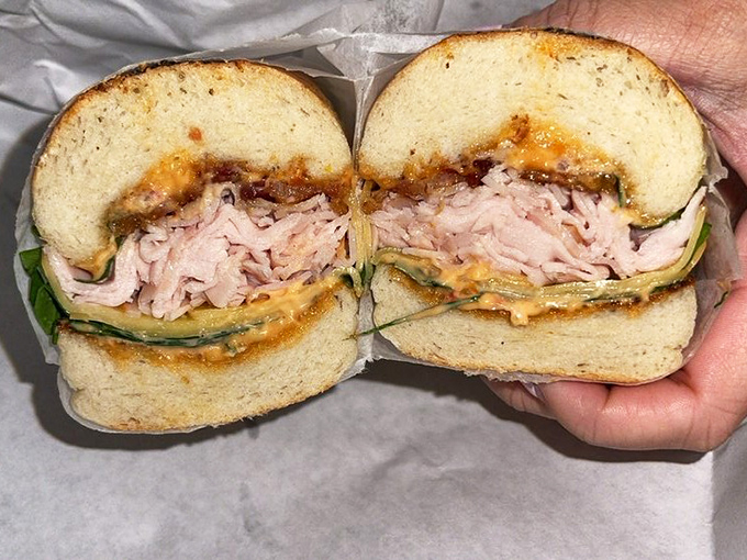 The legendary Smoked Turkey Club in all its cross-sectioned glory. Like architectural blueprints for the perfect lunch, every layer tells a story.