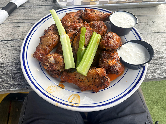 These smoked wings aren't just appetizers—they're the opening act to a symphony of flavor. The celery sticks are just there to make you feel virtuous.