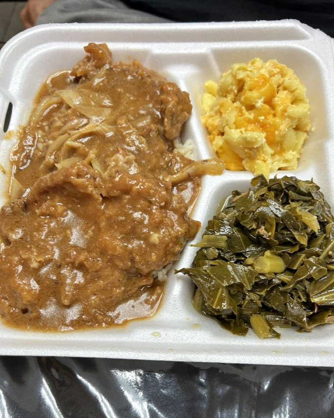 The legendary smothered pork chop arrives like a gravy-drenched dream, flanked by mac and cheese and collard greens that refuse to be mere sidekicks.