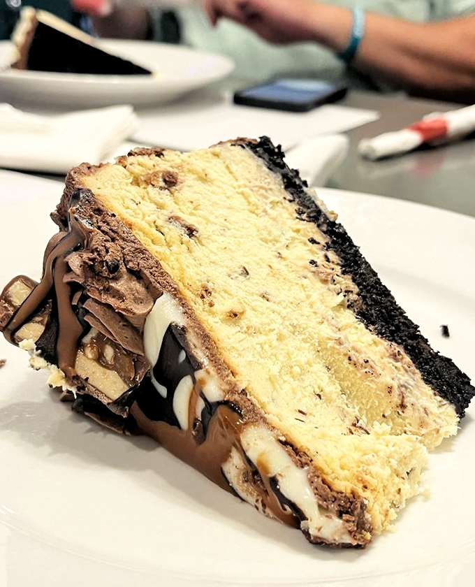 This isn't just cake, it's architecture &ndash; layers of vanilla, chocolate, and Oreo crust creating the Taj Mahal of dessert experiences.