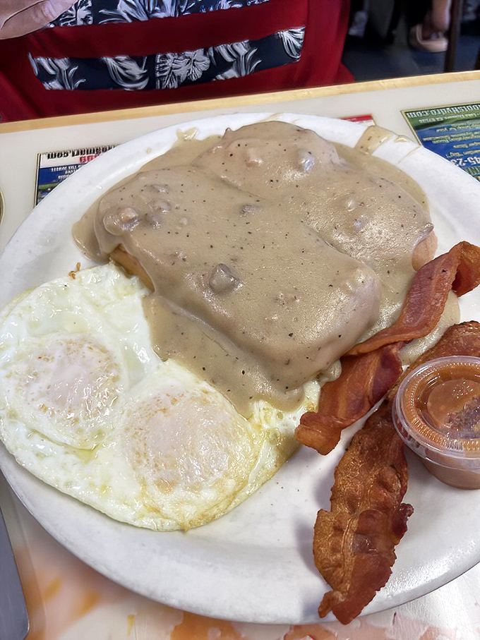 This is what Southern comfort looks like on a plate &ndash; biscuits drowning in gravy, eggs, and bacon perfection.