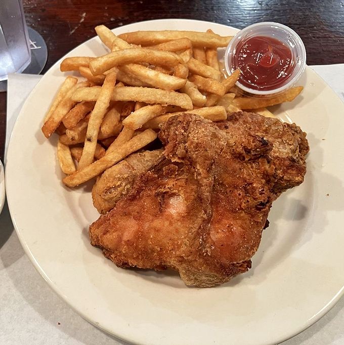 Behold the star of the show: golden-brown fried chicken that shatters with each bite. This isn't just dinner&mdash;it's a religious experience with extra napkins.