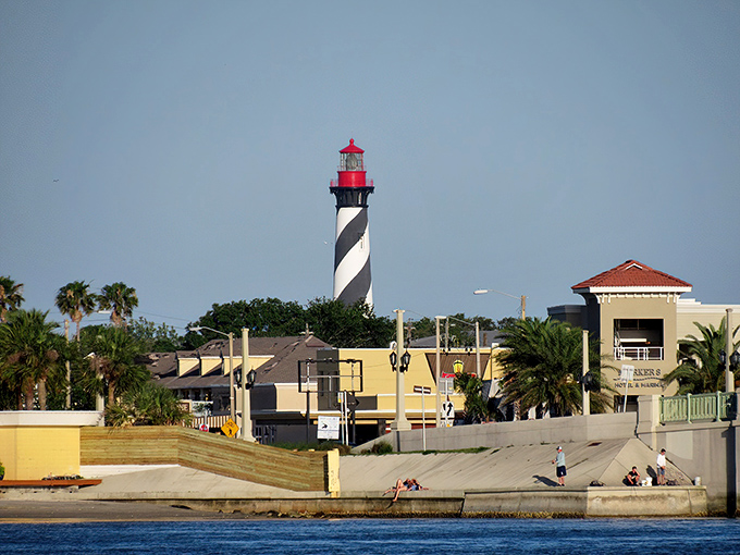 St. Augustine's lighthouse stands guard like a candy-cane-striped sentinel, watching over centuries of maritime mischief.