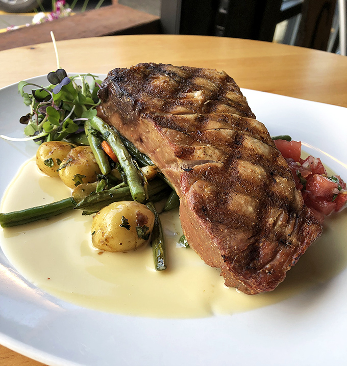 Behold the steak that launched a thousand road trips. Perfectly seared, surrounded by garden-fresh vegetables, this plate is Ohio's answer to carnivore prayers.