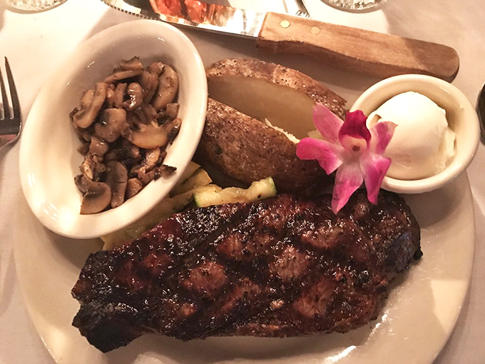 This isn't just a steak; it's a masterclass in carnivorous perfection, complete with saut&eacute;ed mushrooms and a baked potato that's practically begging for butter.