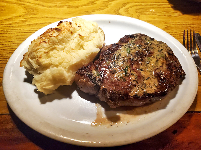 A perfectly seared steak alongside a twice-baked potato—proof that sometimes the simplest combinations create the most profound happiness.