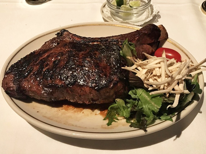 Behold the bone-in ribeye in all its primal glory. This isn't just a steak; it's a masterpiece of marbling that would make Michelangelo weep with carnivorous joy.