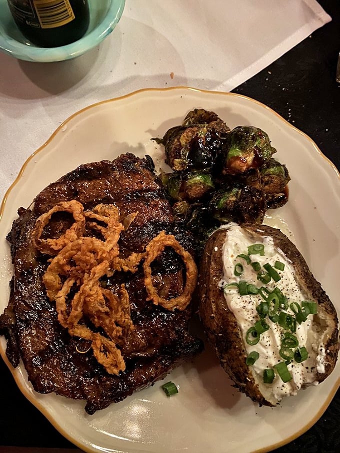 This isn't just a steak&mdash;it's a masterpiece of marbling topped with crispy onions that would make even vegetarians pause for a moment of respect.