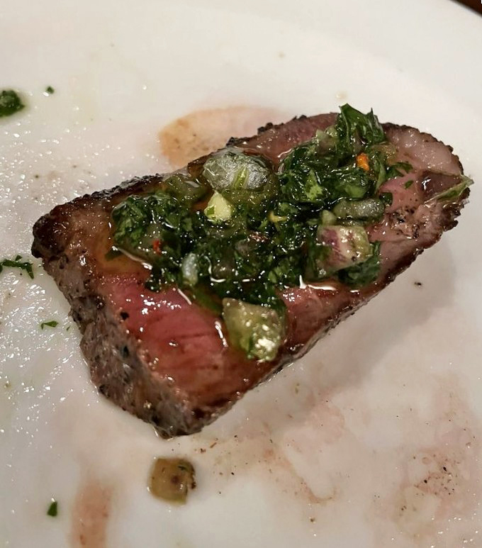 Perfectly seared steak topped with herb butter that melts into a pool of flavor so good you'll want to write poetry about it.