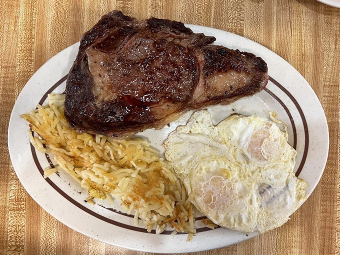 Behold the star attraction: a perfectly seared steak alongside sunny eggs and crispy hash browns&mdash;the holy trinity of diner breakfasts.