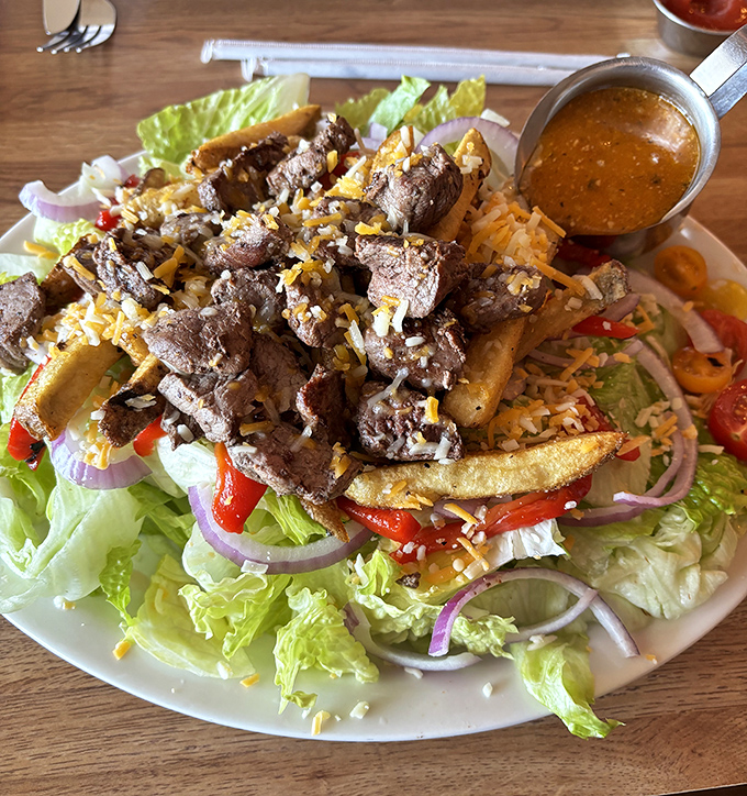 Behold the famous Pittsburgh Steak Salad in all its glory—where perfectly cooked beef mingles with crisp greens and yes, those are French fries right in the salad!