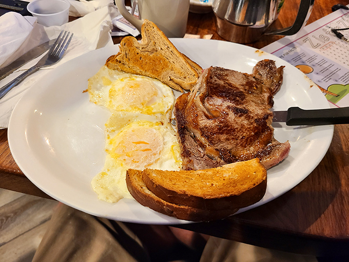 The legendary steak and eggs in their natural habitat. That perfectly seared ribeye isn't just breakfast&mdash;it's the reason alarm clocks were invented.