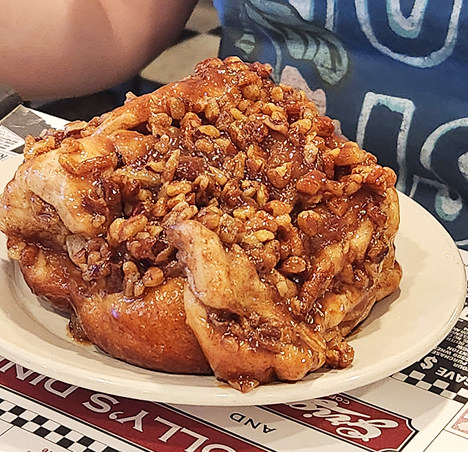This sticky bun isn't just breakfast&mdash;it's an architectural marvel of dough, cinnamon, and enough nuts to make a squirrel weep with joy.