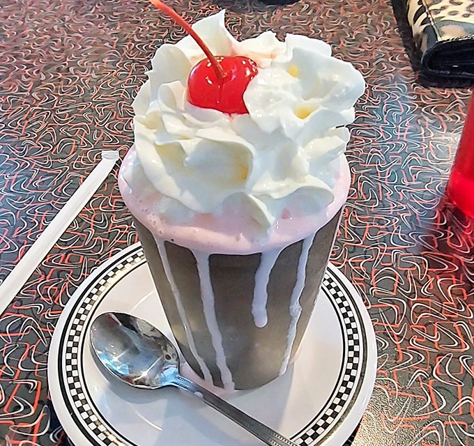 This isn't just a milkshake&mdash;it's architecture in a glass, with whipped cream mountains and that perfect cherry summit waiting to be conquered.