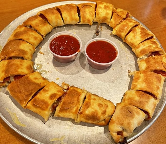 Behold the legendary stromboli&mdash;a golden-brown circle of joy with marinara dipping cups standing by for their supporting role.