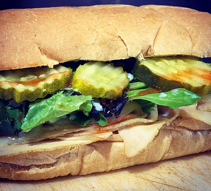 This isn't just a sandwich; it's architecture with pickles. Layer upon perfect layer creating the kind of harmony that makes Mozart seem like amateur hour.