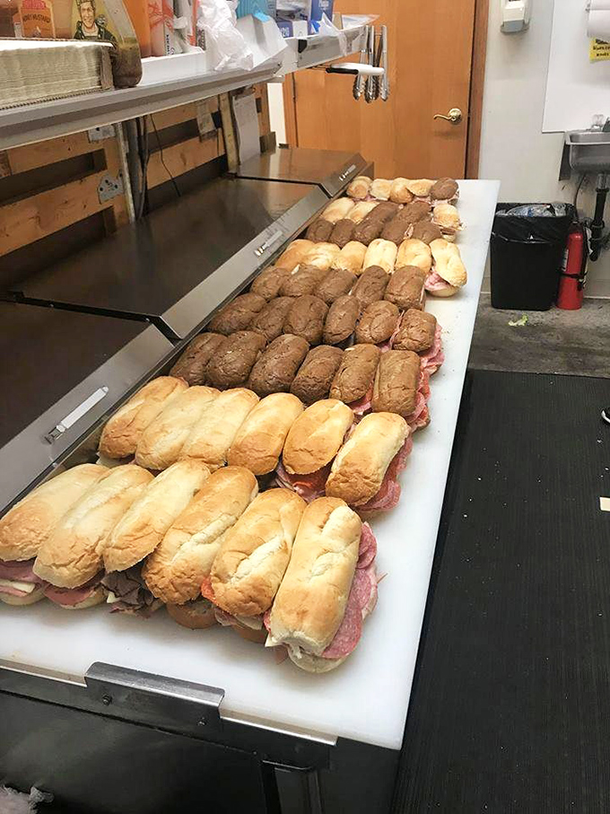 Sandwich perfection in progress &ndash; these freshly assembled subs lined up like soldiers ready to battle hunger with their arsenal of quality ingredients.