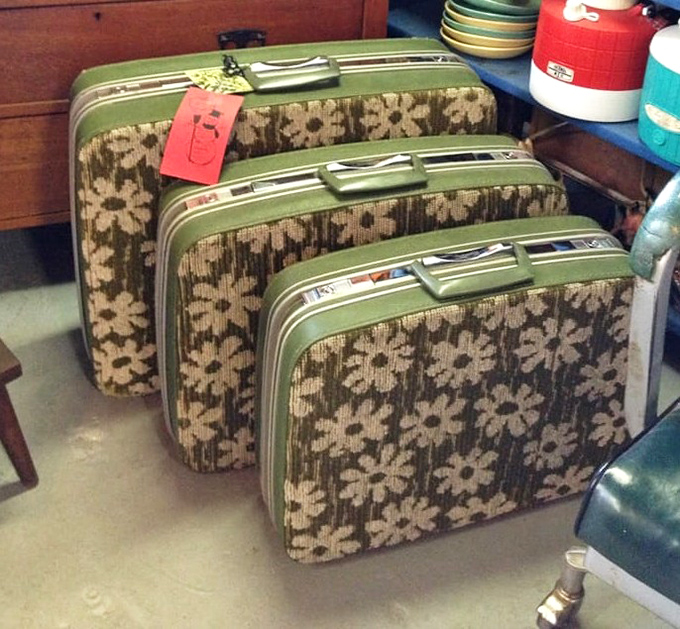 A matching set of vintage floral luggage that screams "I traveled in style before rolling suitcases ruined the romance of looking fabulous at train stations."