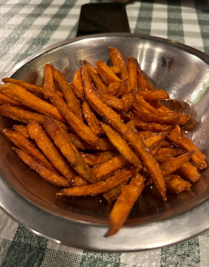 Behold the golden beauties that have food lovers planning road trips – perfectly seasoned sweet potato perfection.