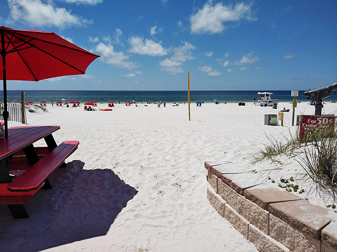 Beach access that looks like it was designed by someone who actually goes to beaches. Red umbrellas, white sand, and blue water&mdash;America's most delicious color palette.