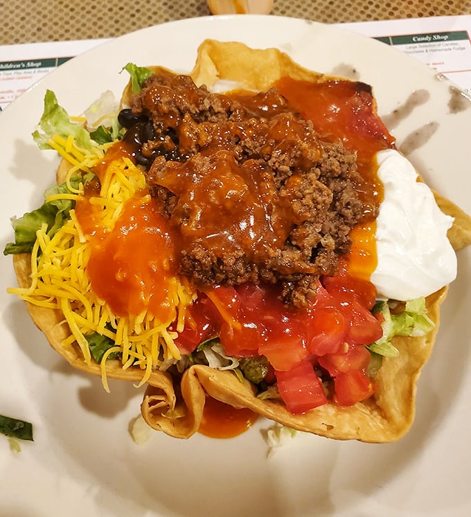 The legendary taco salad arrives like edible architecture&mdash;a crispy tortilla cathedral housing a congregation of seasoned beef, cheese, and fresh vegetables.