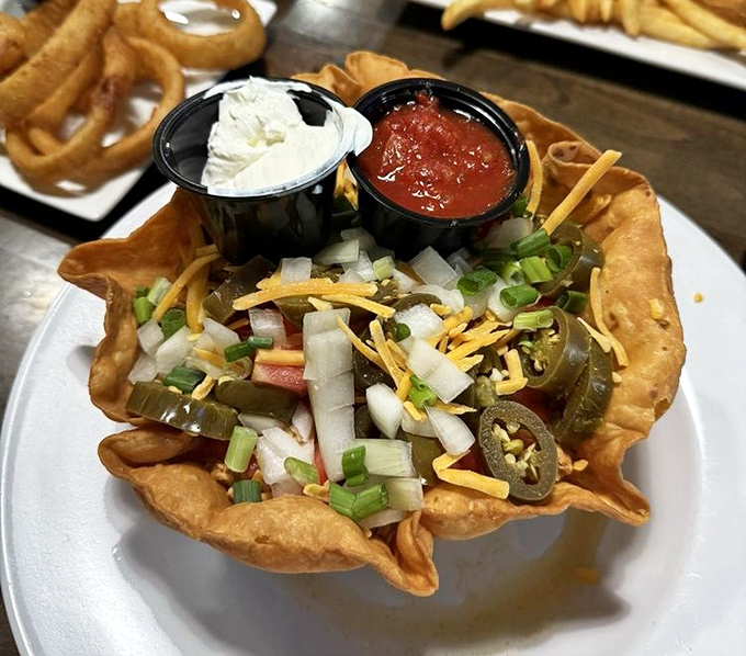 The famous taco salad arrives like edible architecture &ndash; a crispy tortilla bowl cradling fresh ingredients with salsa and sour cream standing by as faithful sidekicks.