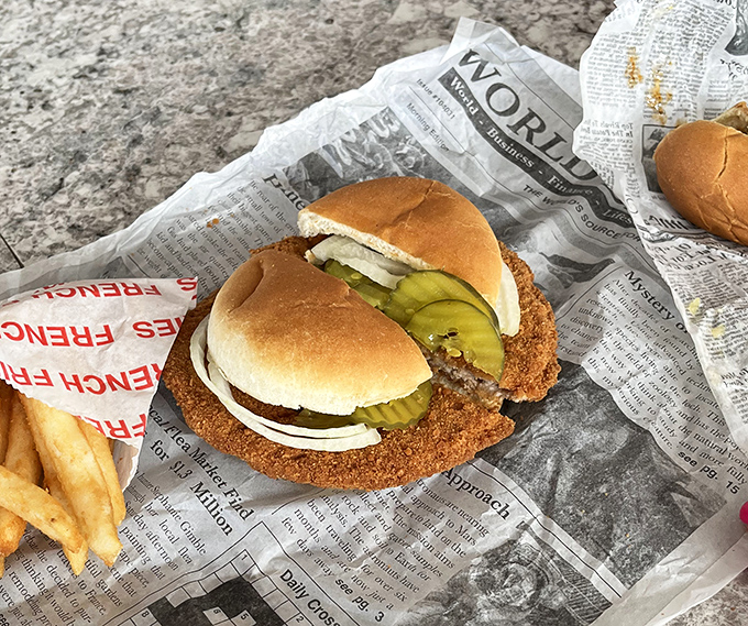 The legendary tenderloin sandwich: where the meat decided the bun was merely a suggestion. This crispy masterpiece requires both hands and possibly a roadmap.