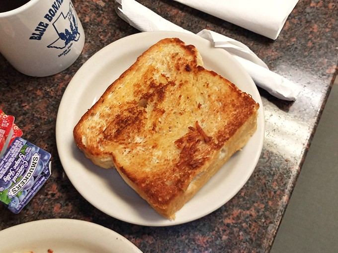 Texas toast perfection&mdash;golden-brown, butter-soaked, and substantial enough to support your breakfast dreams. This isn't toast; it's an institution.