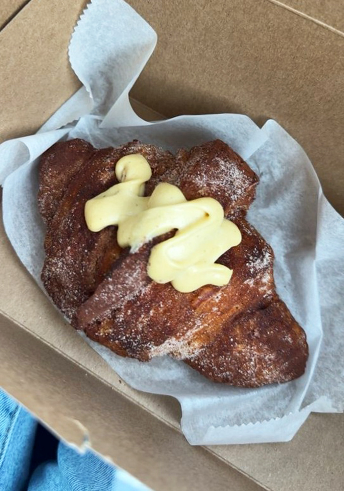 This isn't just a pastry; it's edible architecture with a creamy crown that makes Monday mornings bearable again.