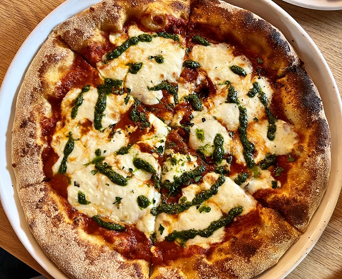 Fresh basil and melted cheese create pizza perfection that would make your Italian grandmother weep with joy.