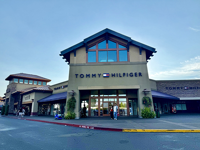 Tommy Hilfiger's lodge-like storefront brings preppy Americana to Oregon's outlet scene. Classic style meets Northwest architecture in perfect harmony.
