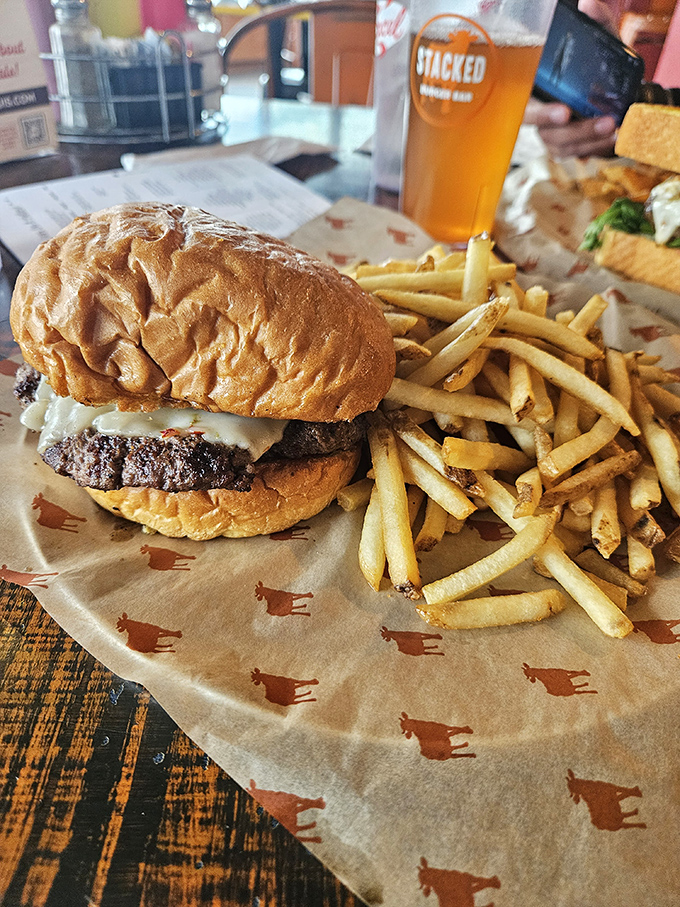 A perfect burger doesn't just happen by accident. This beauty sits alongside golden fries like royalty on parchment.