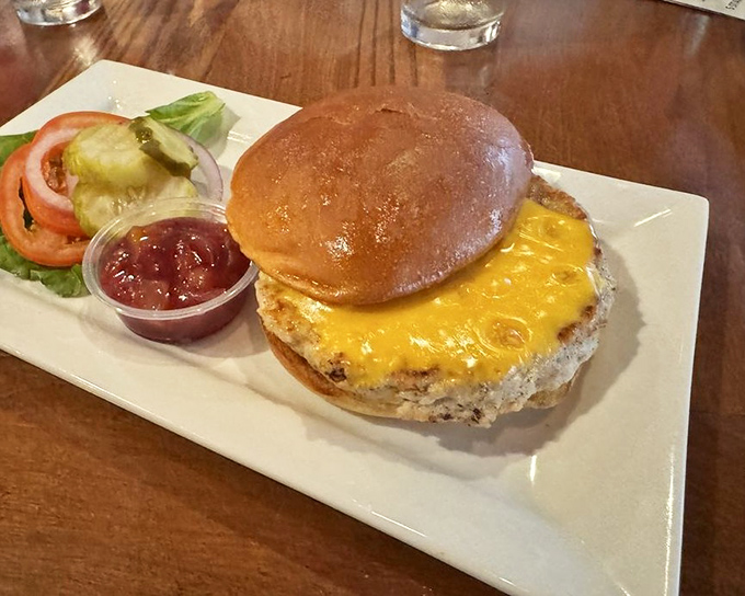The turkey burger arrives like a revelation &ndash; golden cheese cascading over a perfectly grilled patty with a side of cranberry chutney that changes everything.