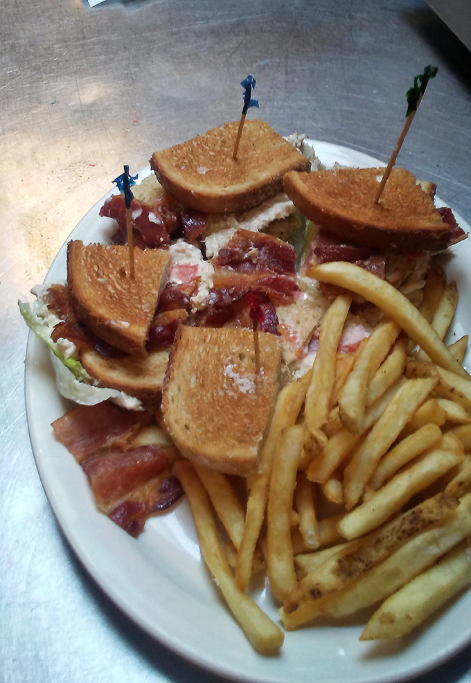 This turkey club stands tall and proud, held together by those fancy toothpicks that mean business.