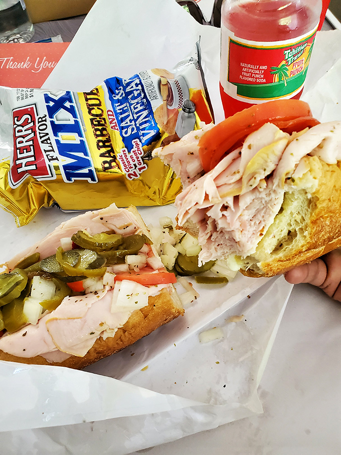Turkey hoagie perfection meets classic potato chip crunch. That strategically placed pickle slice isn't an accident—it's sandwich architecture at its finest.
