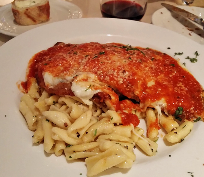 Behold the star attraction: veal parmesan that's fork-tender beneath its crispy coating, blanketed in melted cheese and that perfect marinara. Dreams do come true.