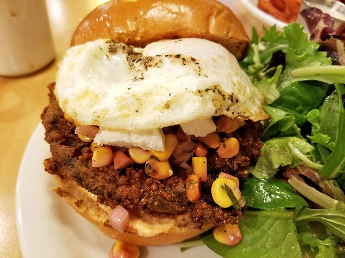 Not your average burger! This masterpiece topped with a perfectly fried egg and fresh corn salsa proves vegetables can party too.