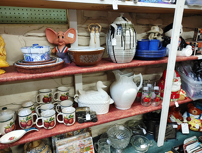 Grandma's china cabinet exploded in the best possible way. Apple-patterned mugs, milk glass treasures, and that mouse figurine your inner child desperately wants.