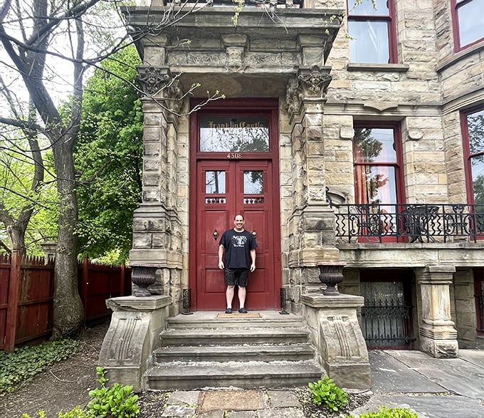 Even the bravest ghost hunters occasionally need photographic proof they survived the experience. The massive doorway makes most visitors look decidedly snack-sized.