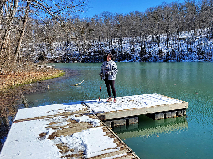 Winter transforms Spring Mill Lake into a serene blue mirror, offering solitude and reflection for the brave dock-standing explorer.