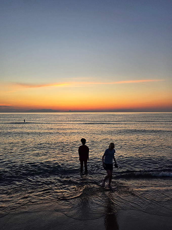 Silhouettes against a sunset canvas – this is how memories are made at Weko Beach, one twilight moment at a time.
