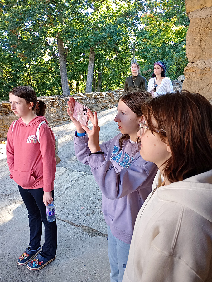 Visitors explore the castle grounds, capturing memories of this unexpected medieval outpost nestled in the Illinois countryside.