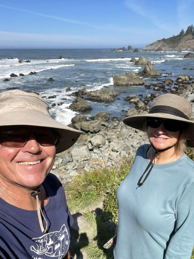 Two happy explorers proving that matching sun hats are the secret to a successful coastal adventure.