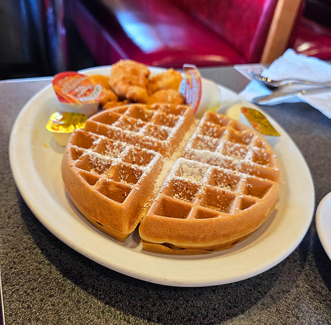 Golden waffle perfection with a dusting of powdered sugar&mdash;the grid pattern practically engineered to hold maximum syrup.