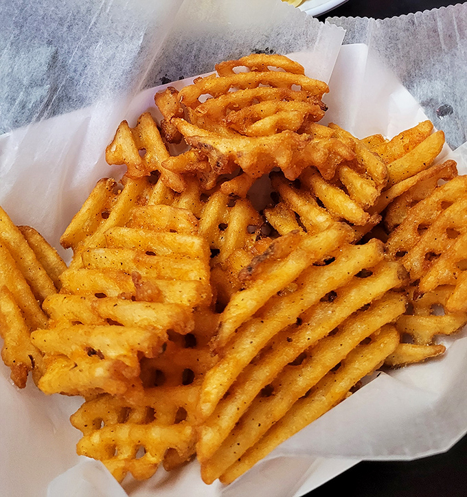 Behold the waffle fries&mdash;architectural marvels of potato engineering with their perfect grid pattern designed to maximize both crispiness and ketchup-holding capacity.