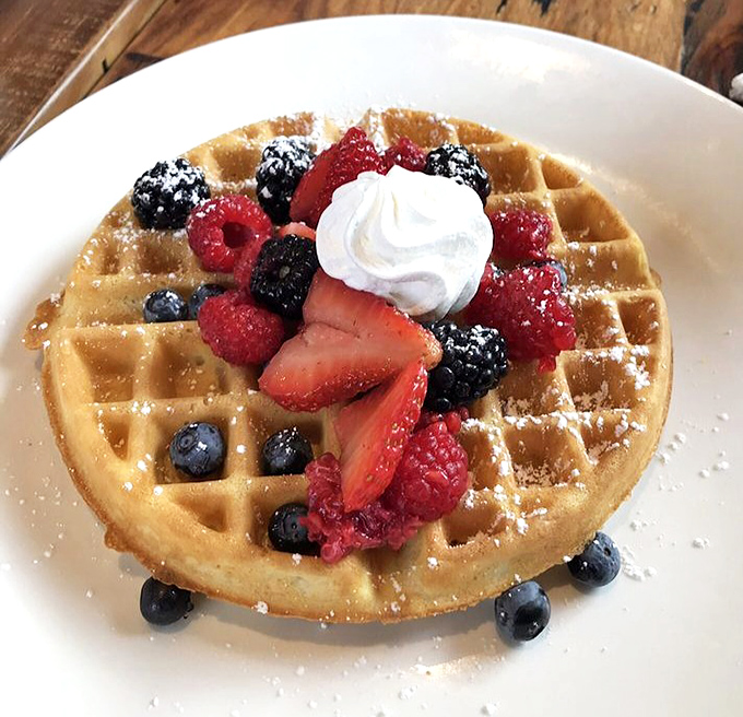 This Belgian waffle isn't just breakfast, it's a berry-topped masterpiece that makes you wonder why you ever settled for frozen toaster versions.