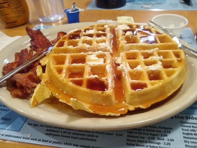 Behold the golden masterpiece—a waffle so perfectly formed, with those little squares practically begging to be filled with maple syrup rivers.