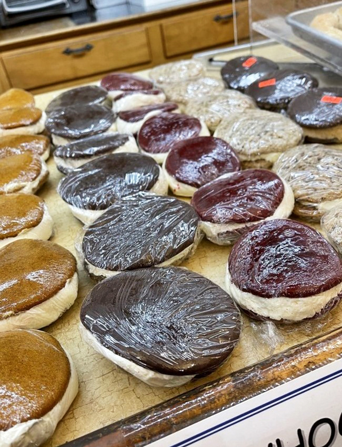 Whoopie pies lined up like edible hockey pucks &ndash; chocolate, vanilla, and berry versions waiting to jump into your take-home box.