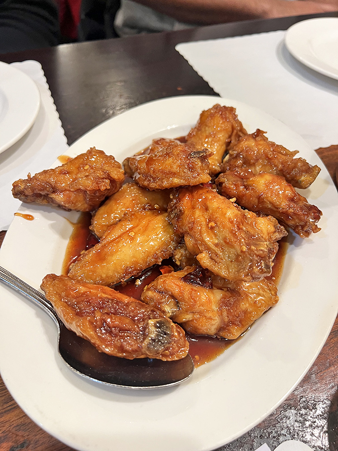 The star of the show: dry-fried chicken wings glistening with that addictive sauce. Crispy, sticky, sweet, and savory &ndash; resistance is futile.
