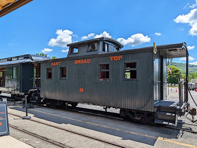Caboose No. 28 stands as a wooden sentinel of railroad history. That "EAST BROAD TOP" lettering might as well read "time machine."